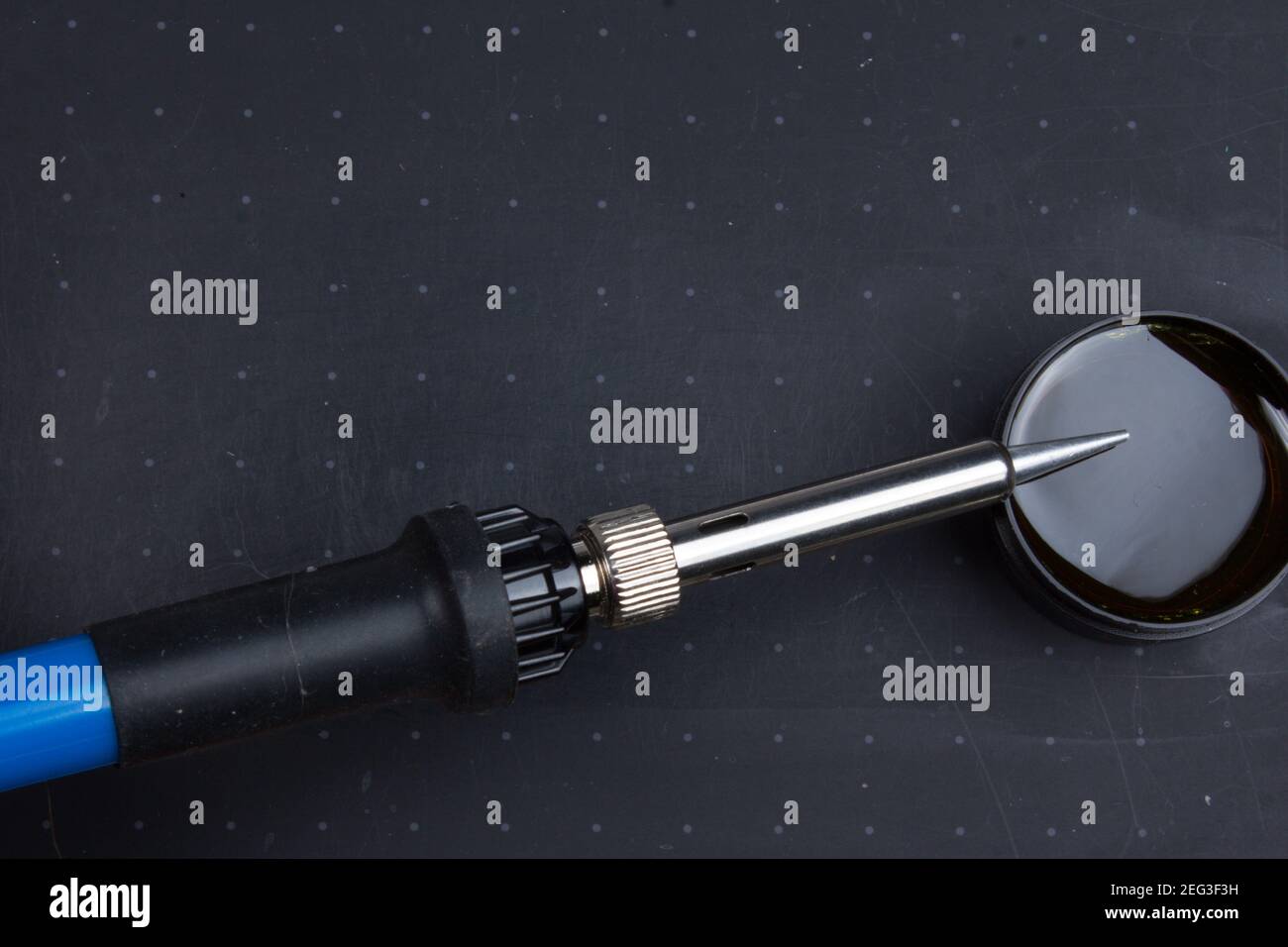 Soldering tools. Soldering iron, and rosin, on a black background Stock ...