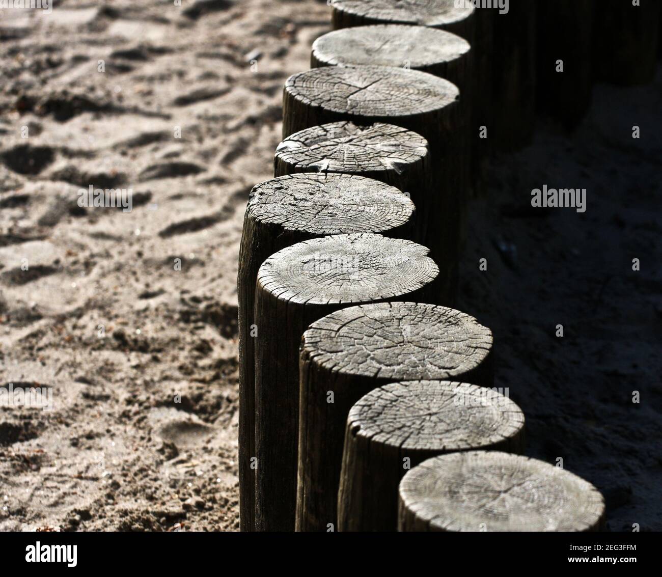 Wooden poles in a playfield in denmark Stock Photo - Alamy