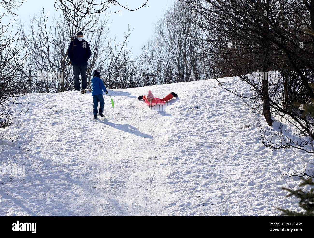 Happy children sliding in winter hi-res stock photography and images ...