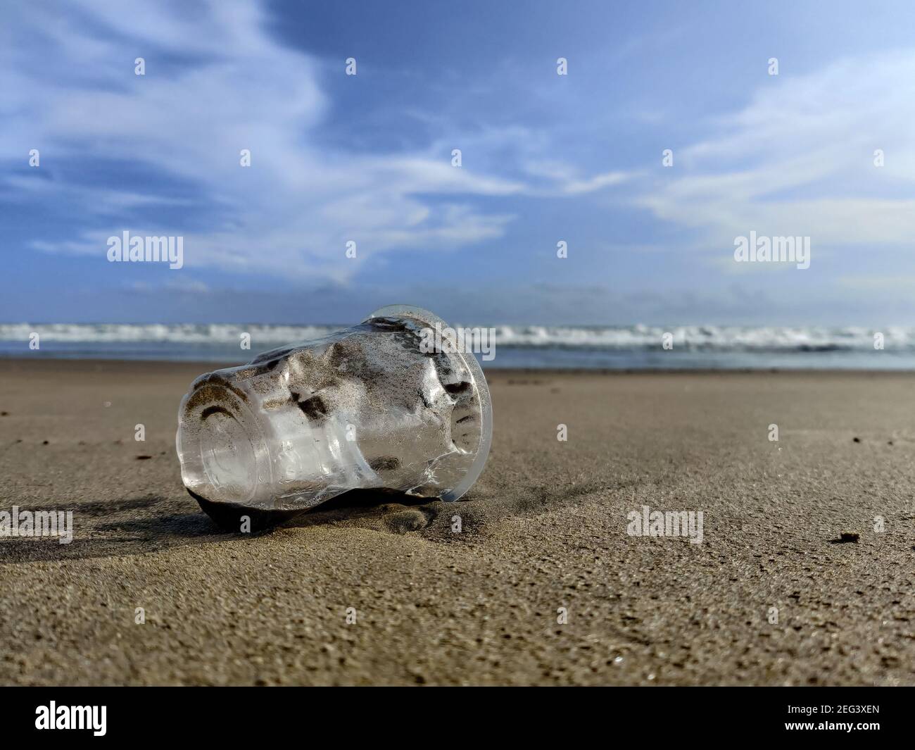 Selective focus of a plastic disposable cup left on a sandy beach Stock ...