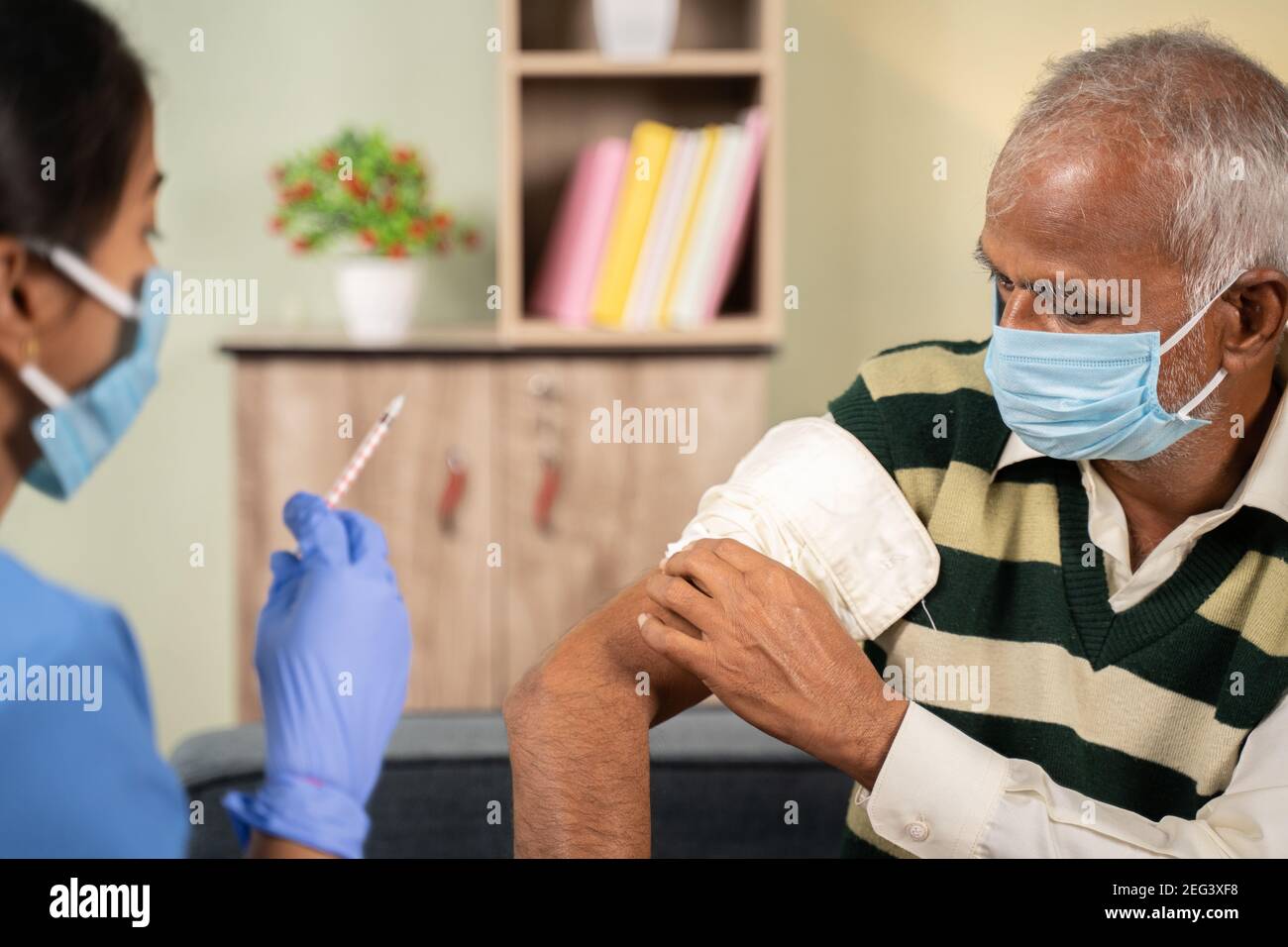 After Doctor giving vaccination shot to elderly patient by syringe or ...
