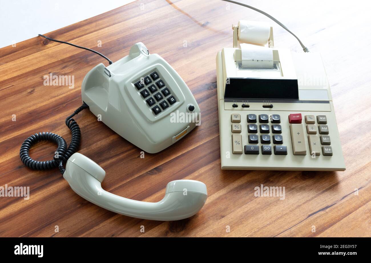 Old fashioned calculator and telephone on desk Stock Photo - Alamy