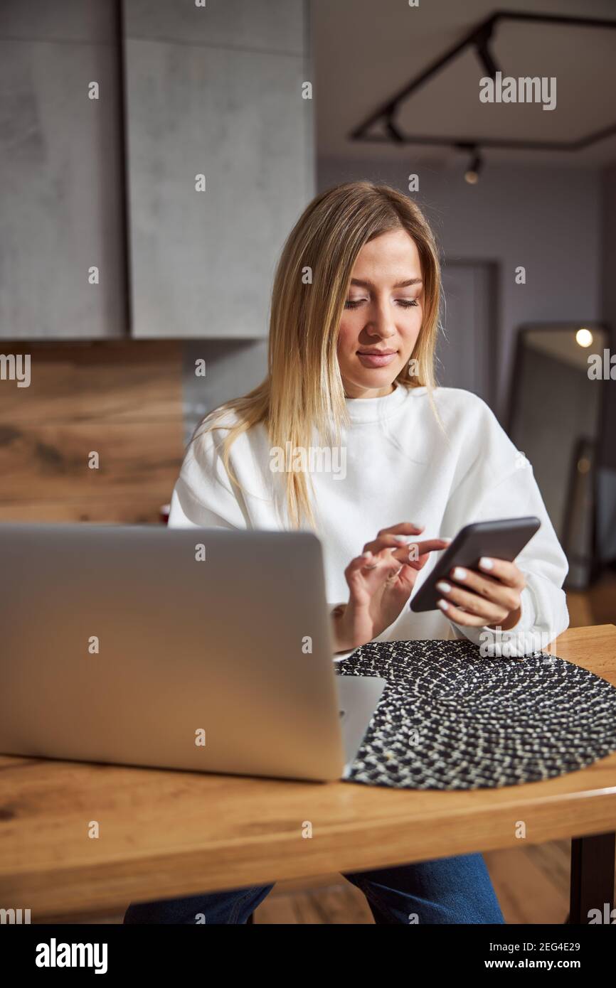 Focused lady clicking on her mobile phone Stock Photo - Alamy
