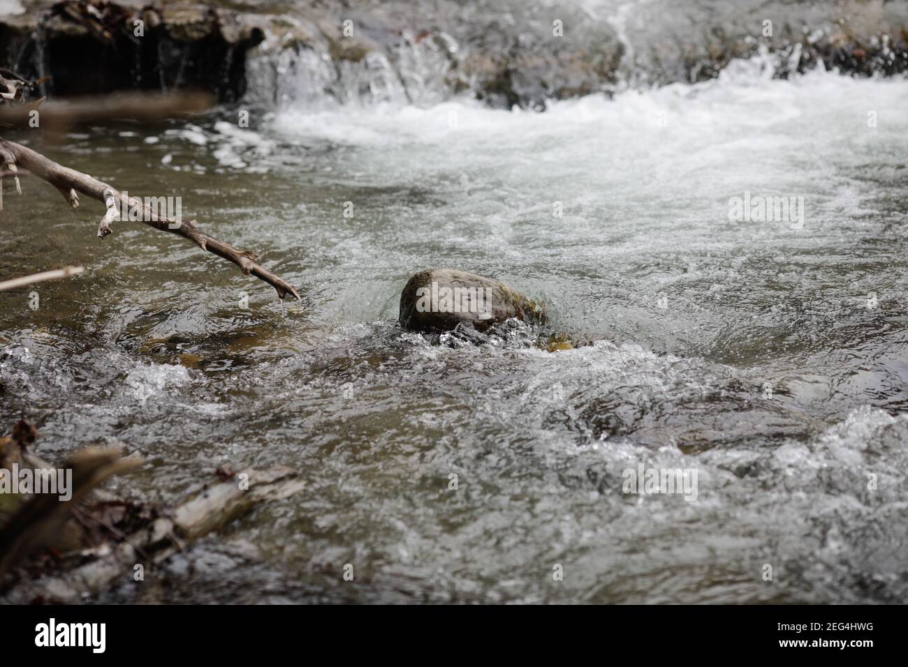 Details with the clear water of a running mountain stream during a cold ...