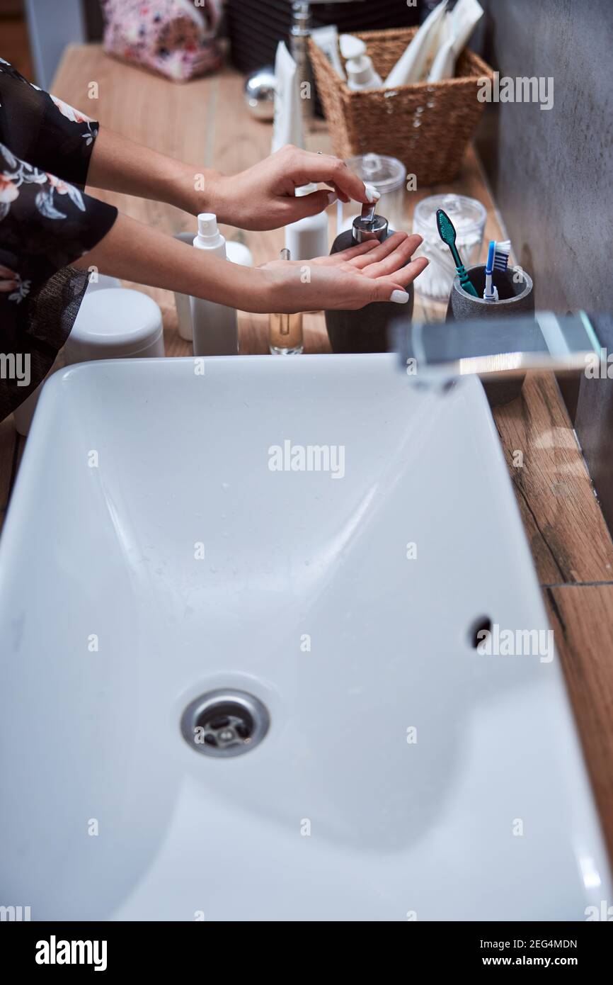 Female pressing on a bottle with liquid soap Stock Photo - Alamy