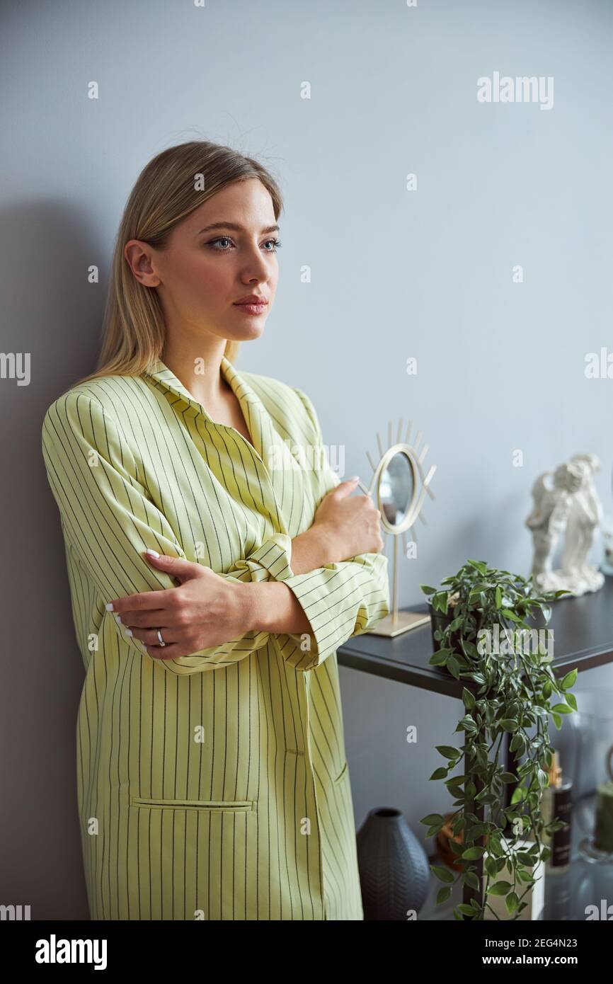Lady folding her arms on chest near a plant Stock Photo - Alamy