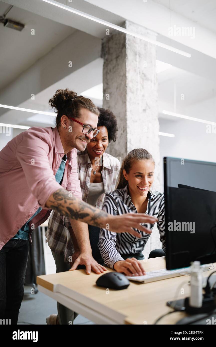 Programmers cooperating brainstorming at information technology company ...