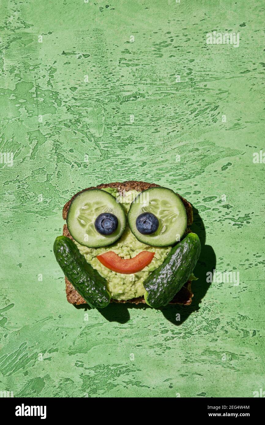 Funny Frog Toast With Cucumber And Mashed Avocado Stock Photo - Alamy