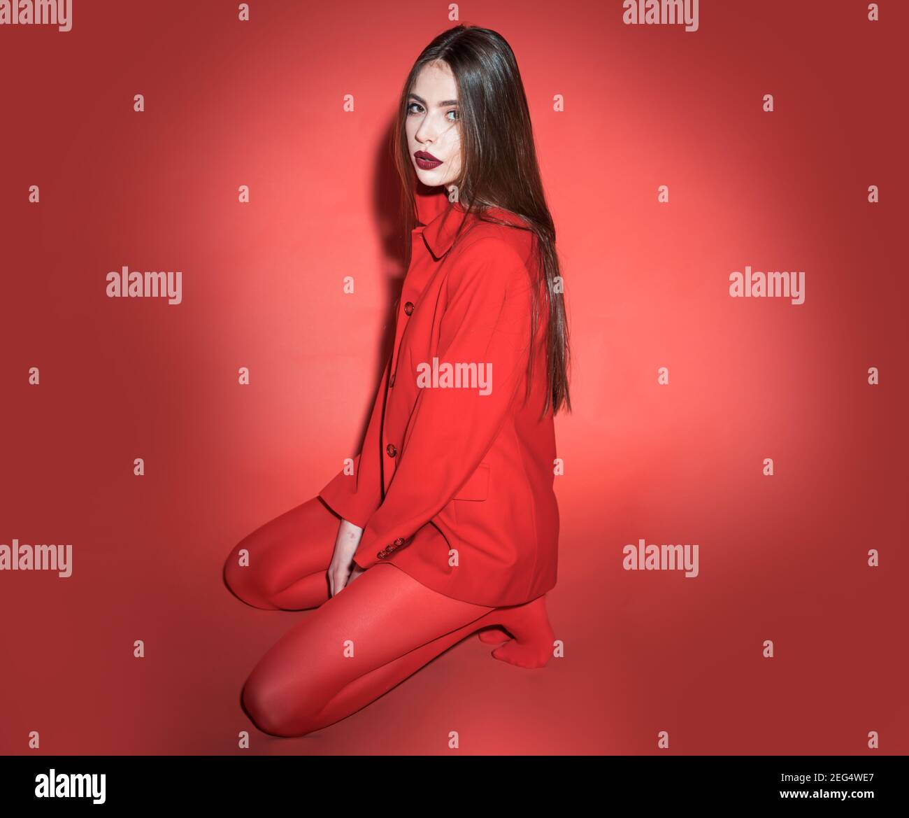 Woman with posing in total red outfit. Fashion concept. Girl on calm ...