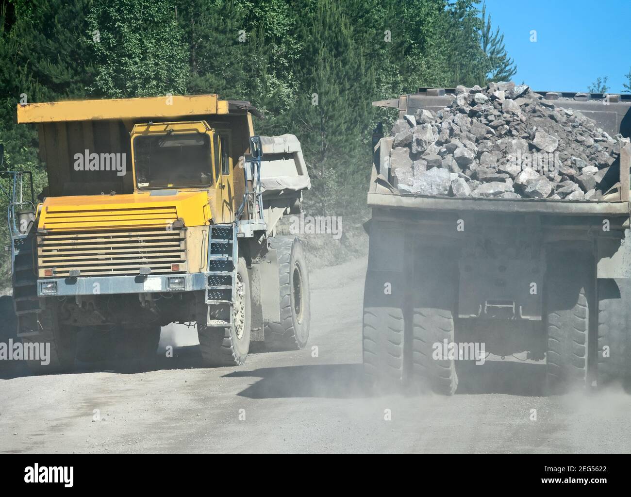 Open-pit operation. Pit dump truck, large-capacity dump truck rides on ...