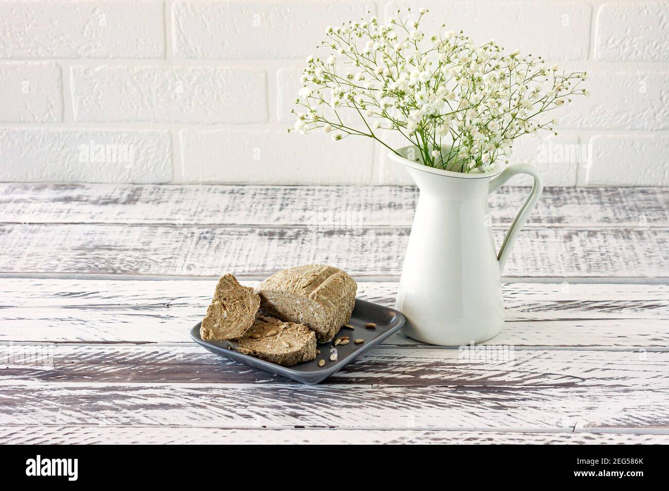 peanut halva on a plate on white wooden table. Oriental dessert from ...