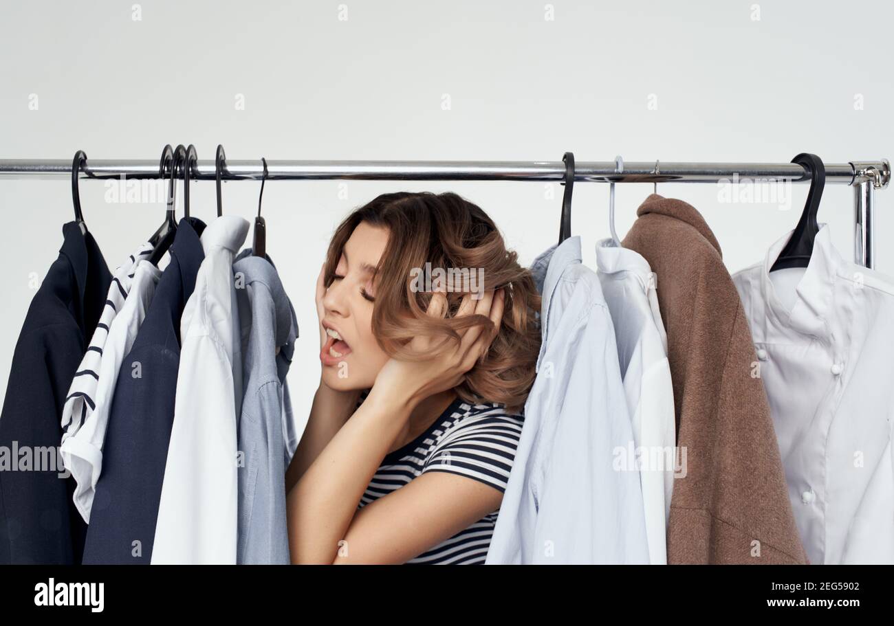 Woman in fitting room with clothes in hand shopping shirt Stock Photo ...