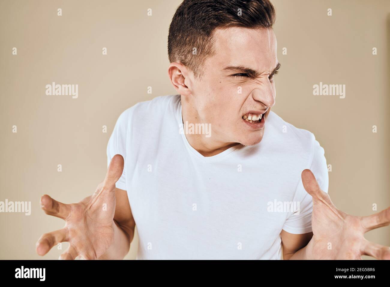Man with displeased facial expression emotions white t-shirt gestures ...