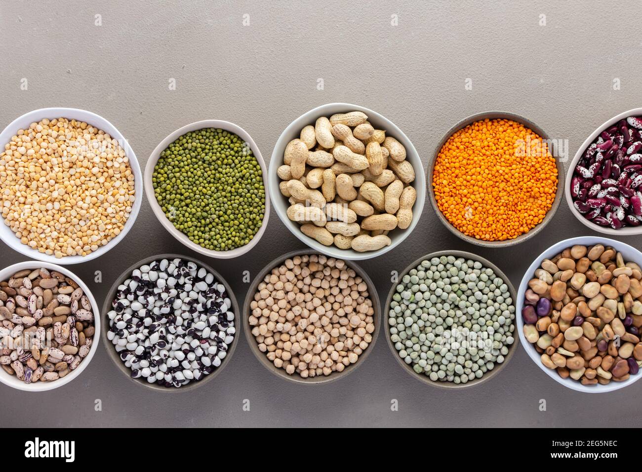Different types of legumes in bowls, green and yellow peas, chickpeas ...