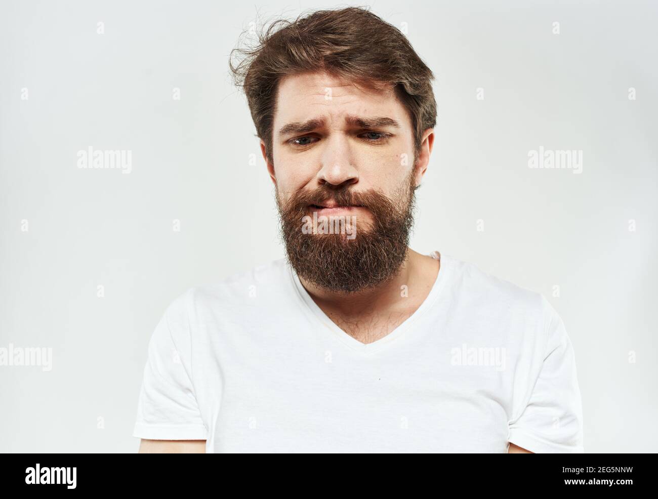 emotional man with beard puzzled look on light background Stock Photo ...