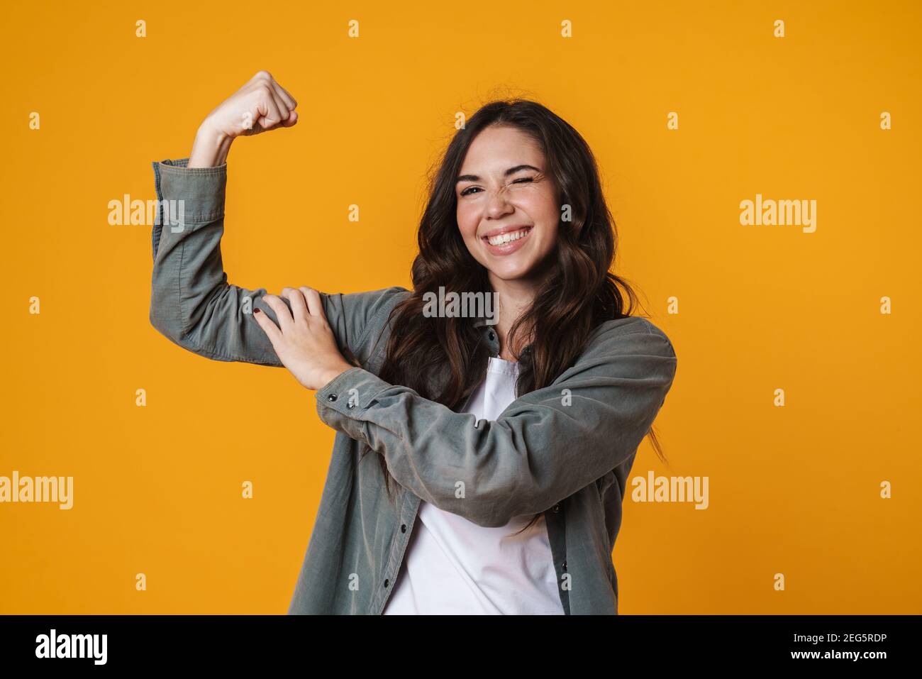 Young woman flexing biceps hi-res stock photography and images - Alamy