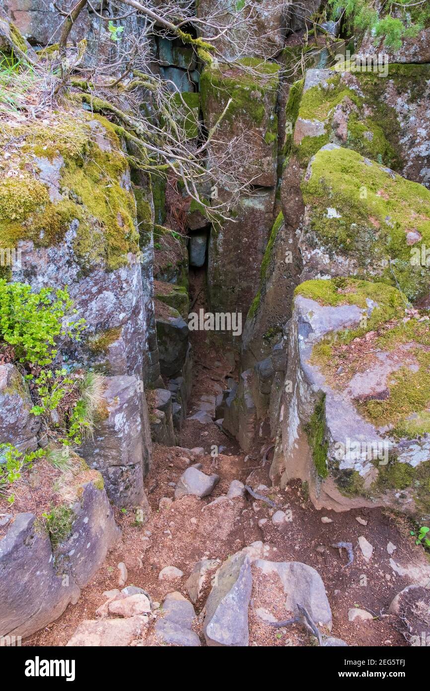 Footpath at a rocky terrain going down in a ravine Stock Photo - Alamy