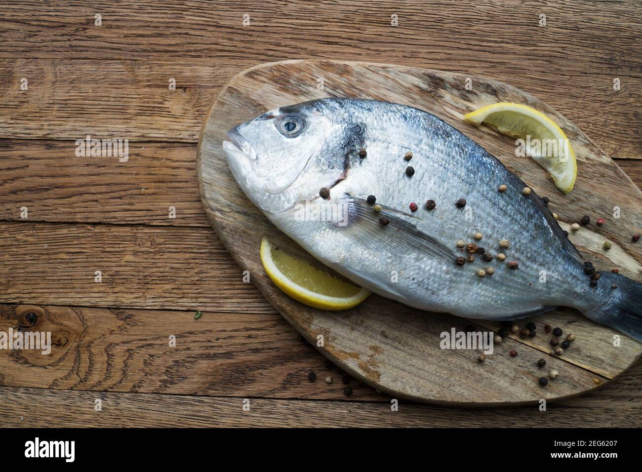 Raw fish cooking and ingredients. Dorado, lemon, herbs and spices. Top ...