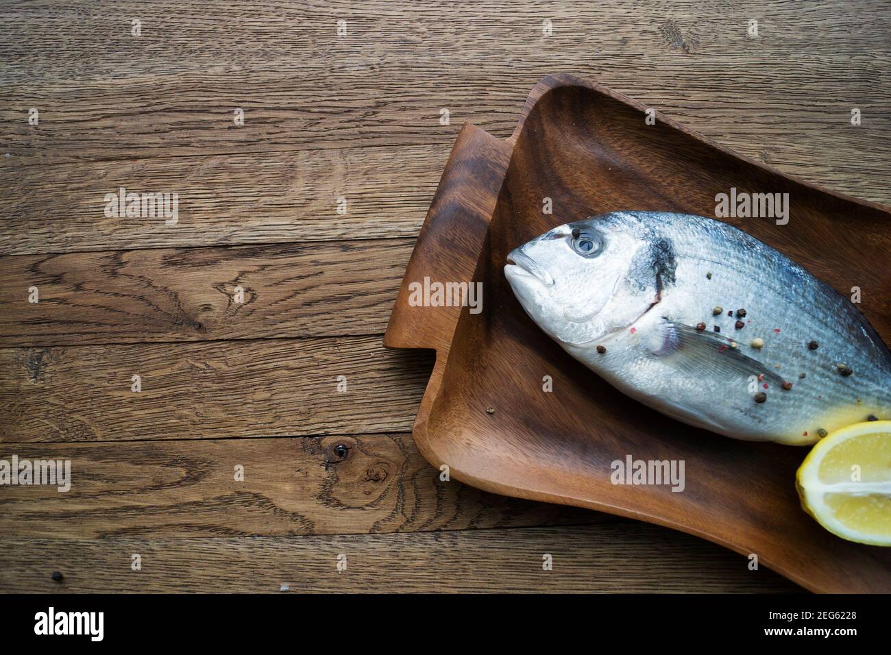 Raw fish cooking and ingredients. Dorado, lemon, herbs and spices. Top ...