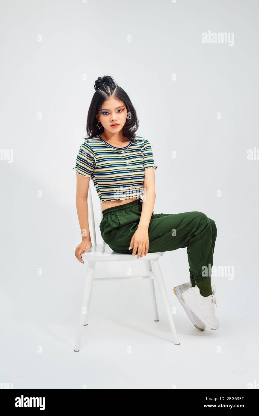 beautiful girl, hair flying in the wind sitting on a chair , smiling ...