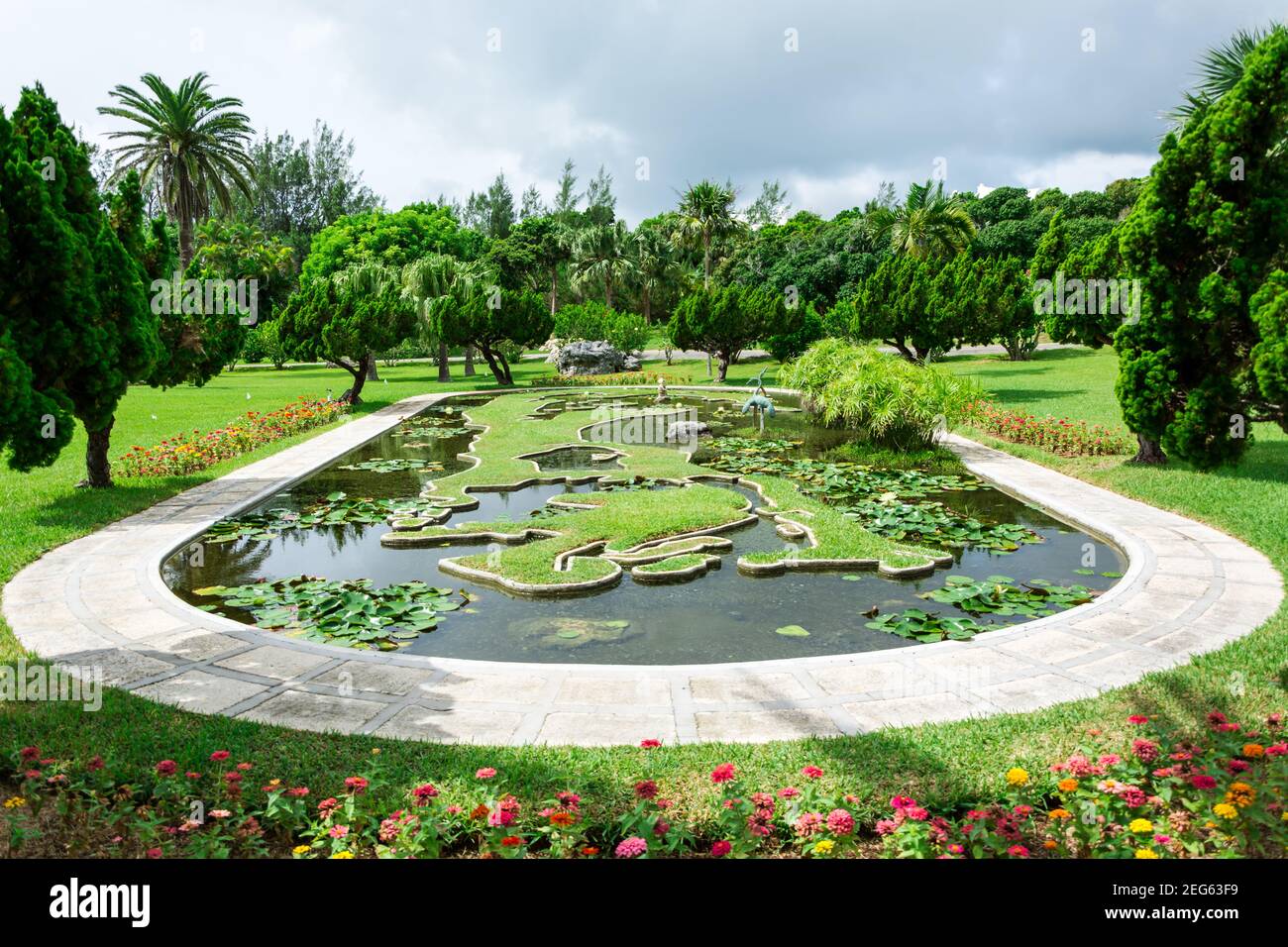 Pond in a garden with various flowers and trees Stock Photo - Alamy