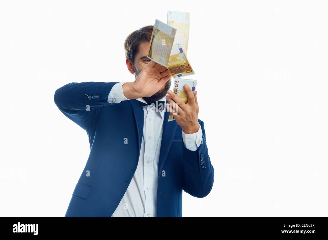 happy man scatter money on light background suit model business finance ...