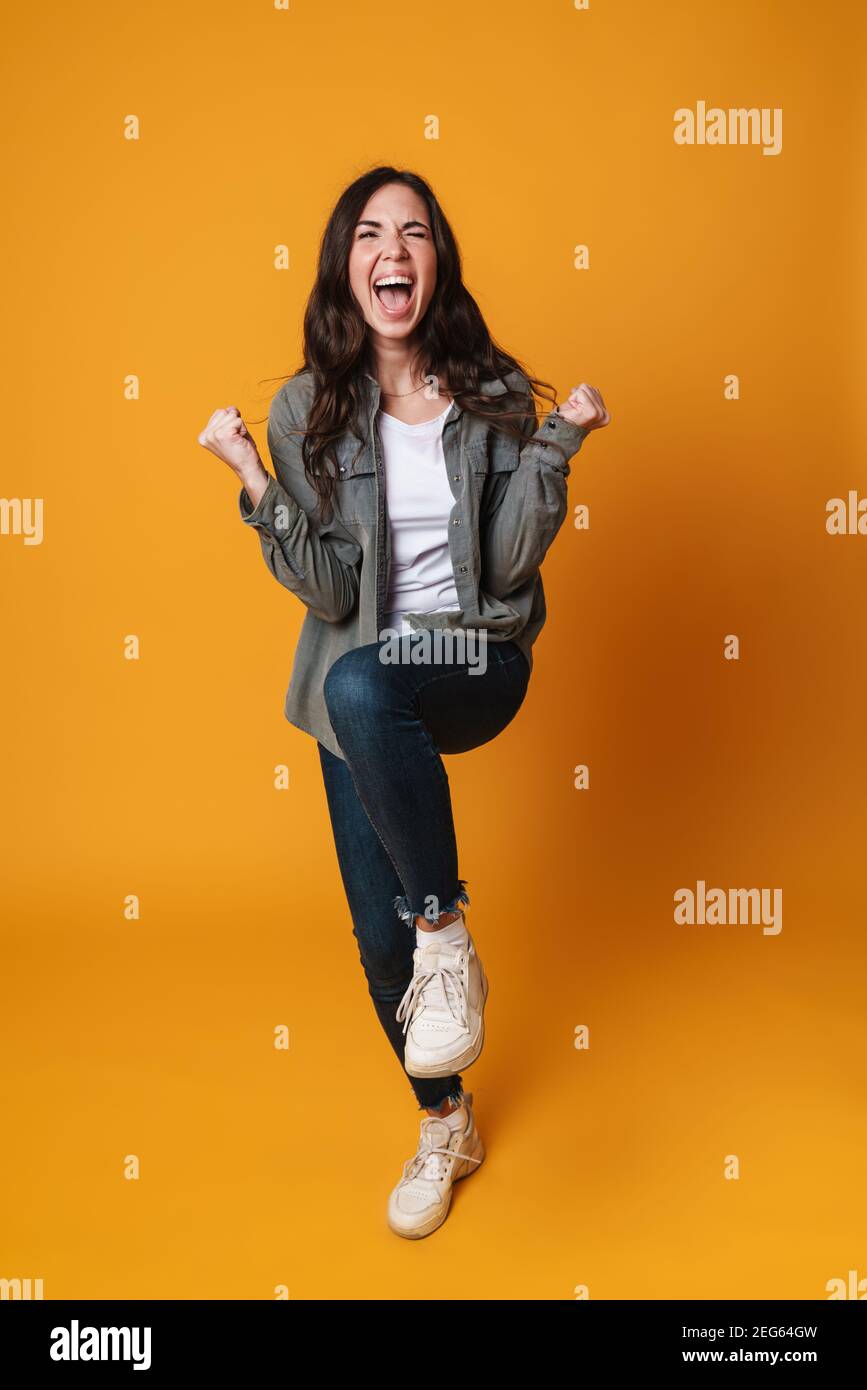 Excited beautiful girl making winner gesture and screaming isolated ...