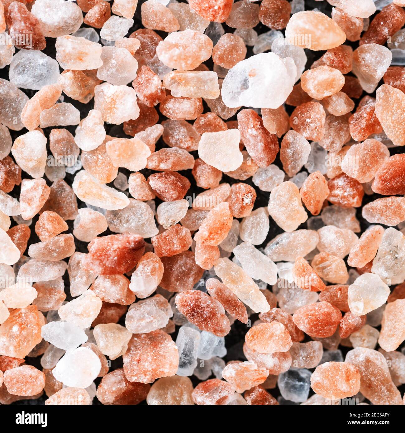 Himalayan pink rock salt on black background. Top view Stock Photo - Alamy