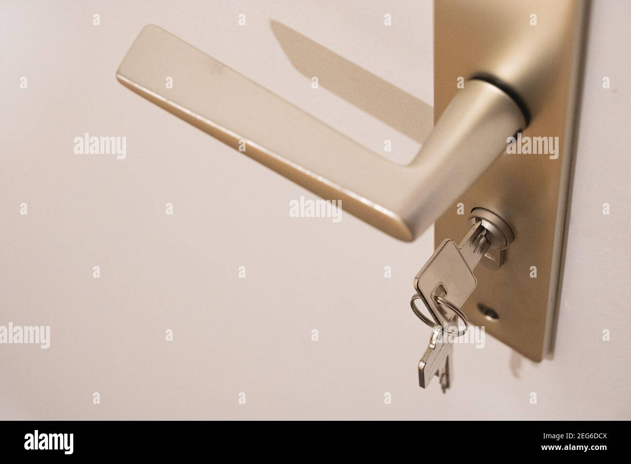 Key in the lock of front door Stock Photo - Alamy