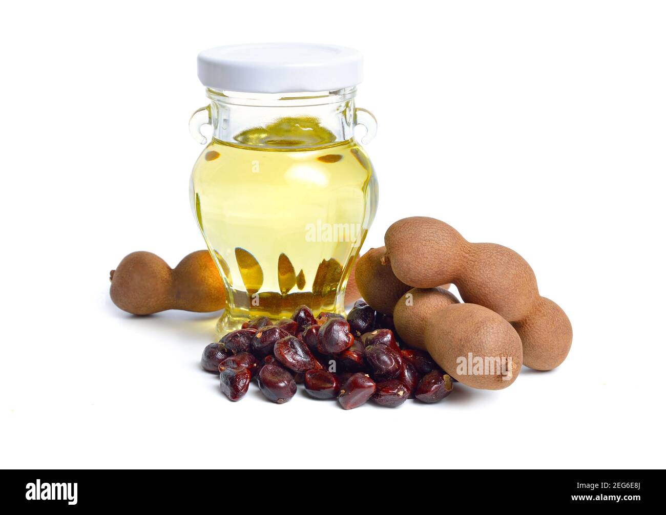 Tamarind oil with fruits and seeds isolated on white background Stock ...