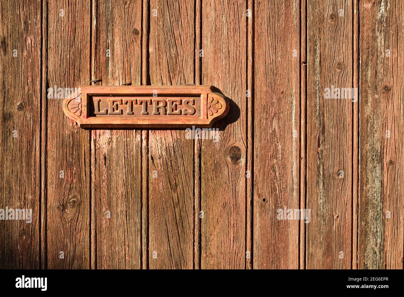 Old Letter Box On A Brown Wooden Door With Inscription lettres In Old Letter Box On A Brown Wooden Door With Inscription lettres In