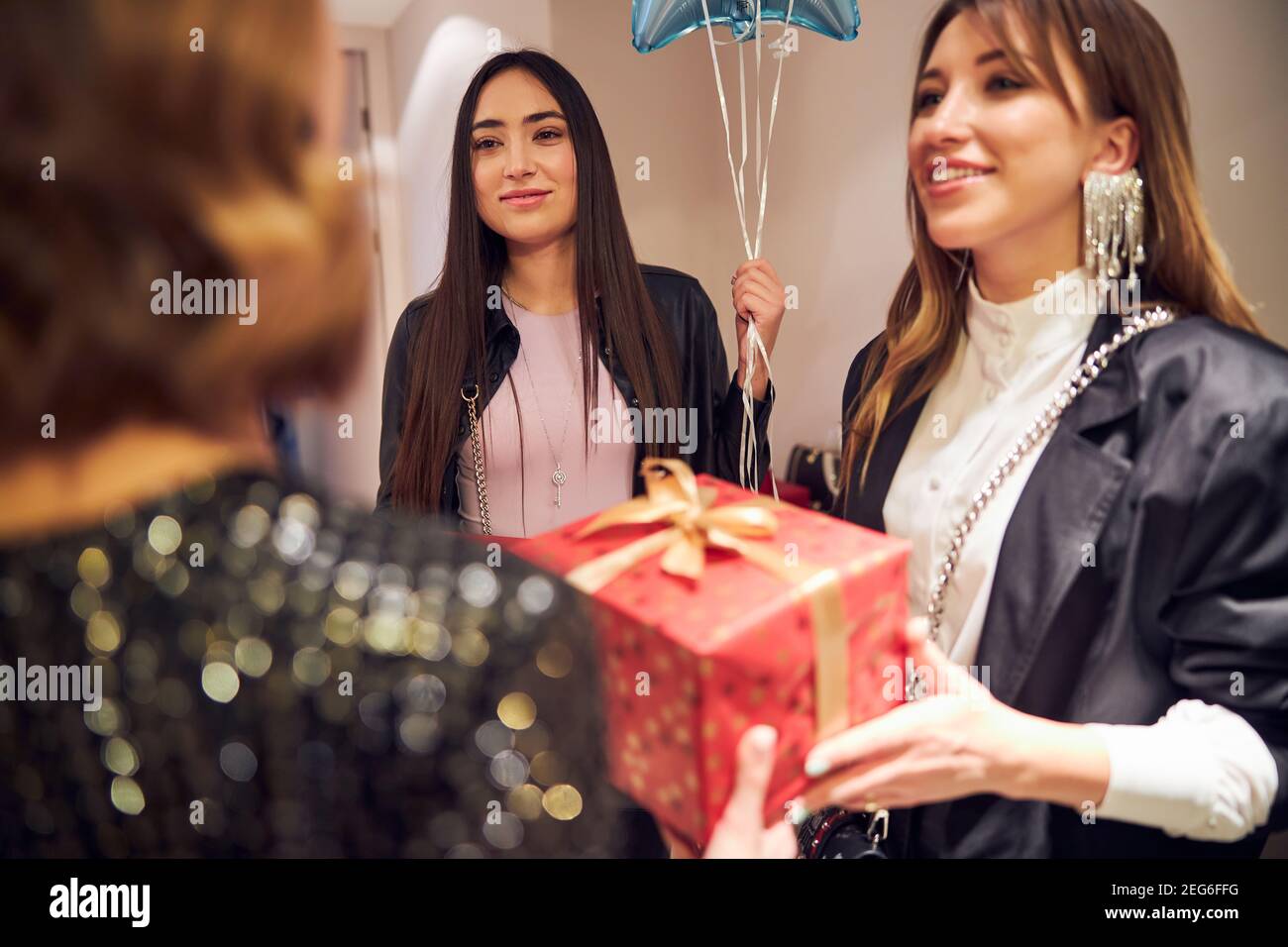 Woman being congratulated by her female friends Stock Photo - Alamy