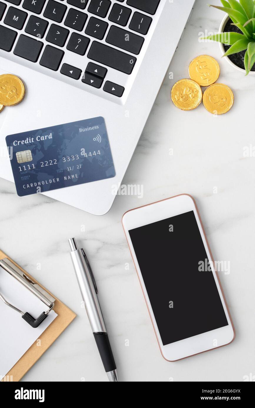 Top view of financial plan concept with credit card, laptop, note on ...
