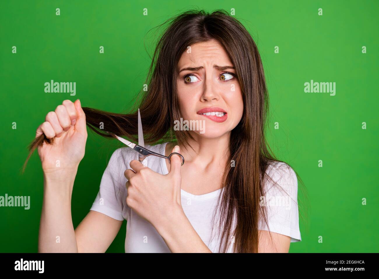 Photo portrait of scared girl cutting hair with scissors isolated on ...