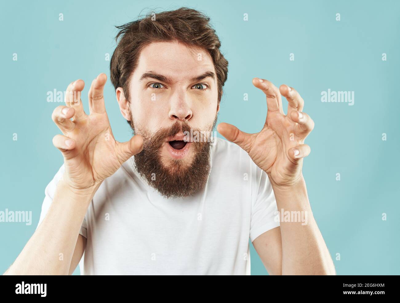 aggressive man yelling on blue background stress irritability emotions ...