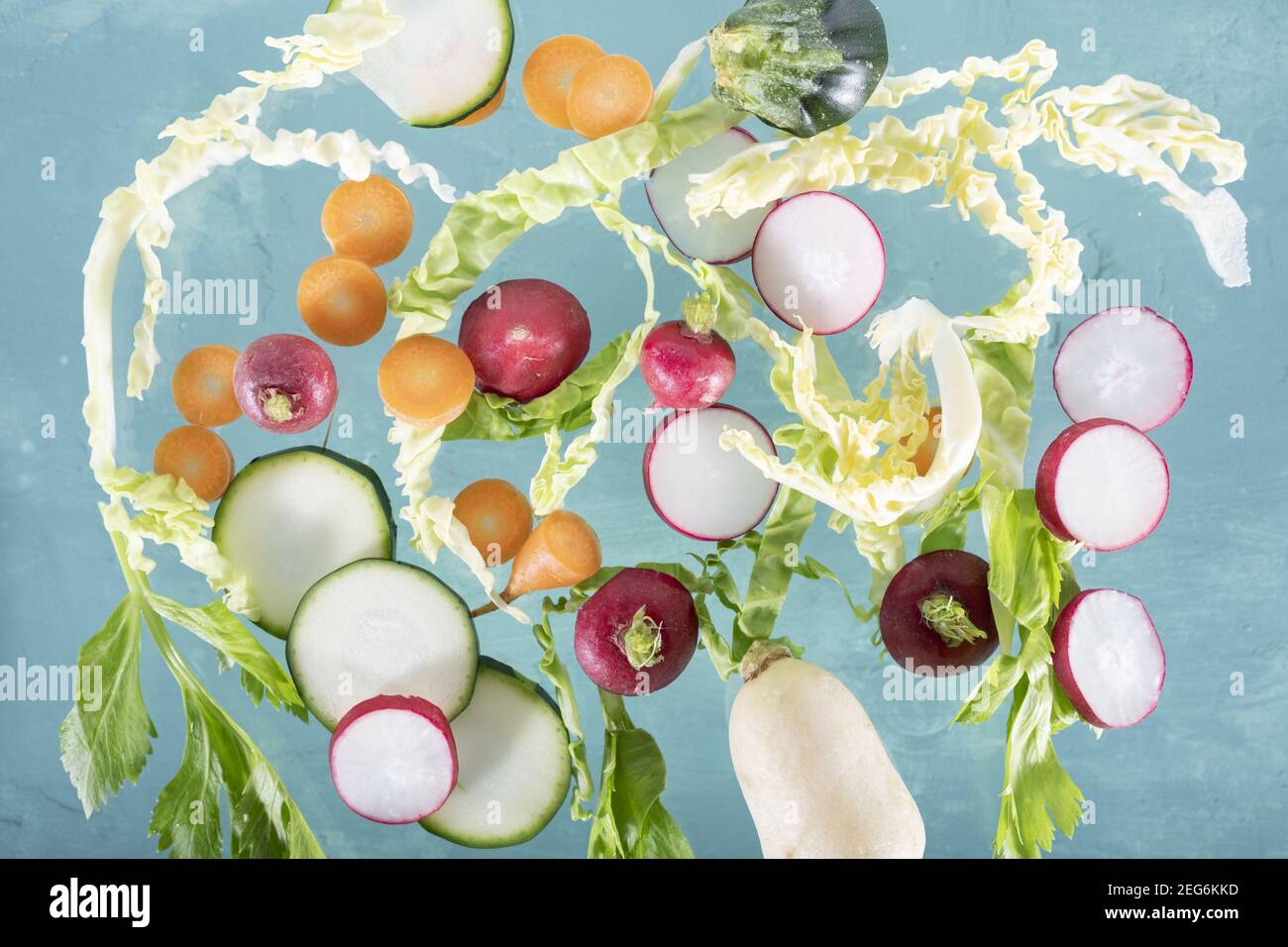 Vegetable ingredients on turquoise background Stock Photo - Alamy