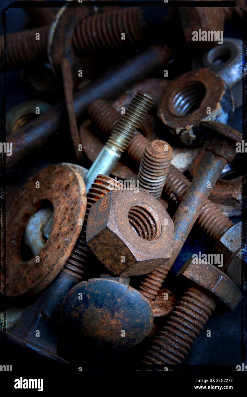 Collection of rusty bolts, nuts, and washers in a disorganized heap at ...