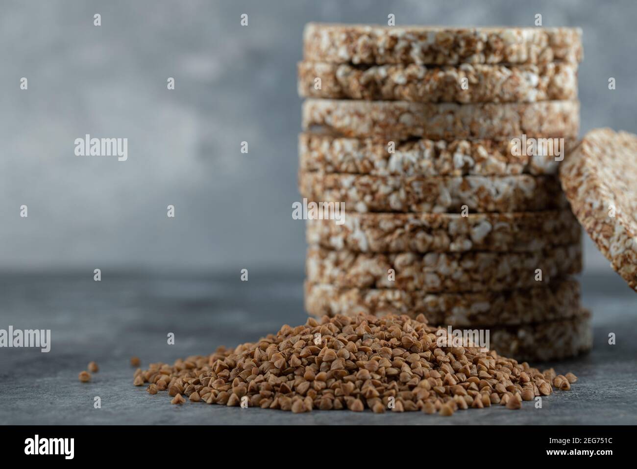 Stack of rice cakes and pile of buckwheat on marble surface Stock Photo ...