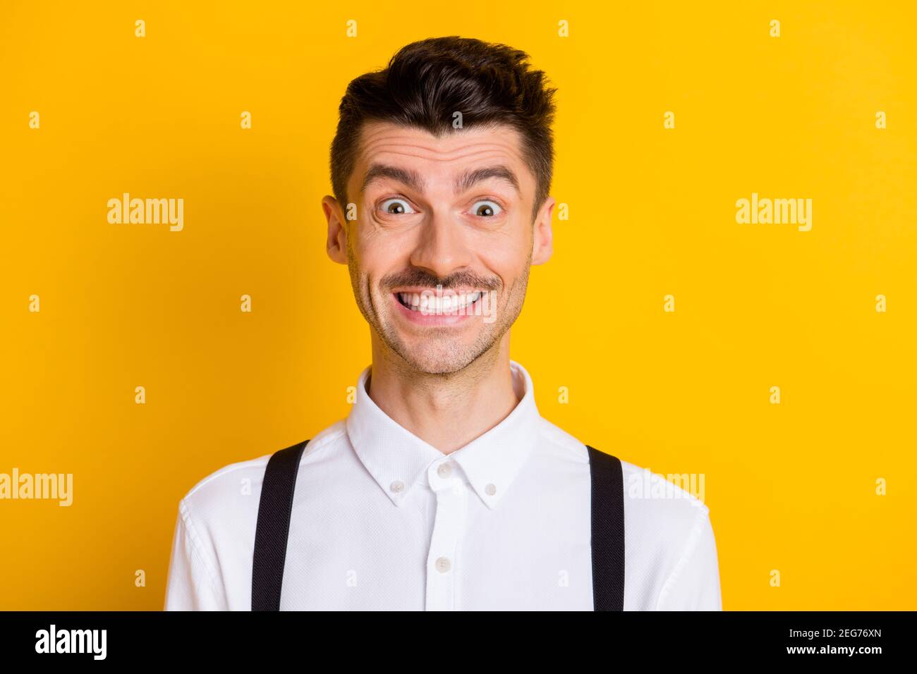 Close-up portrait of nice funny cheerful guy wearing white shirt ...