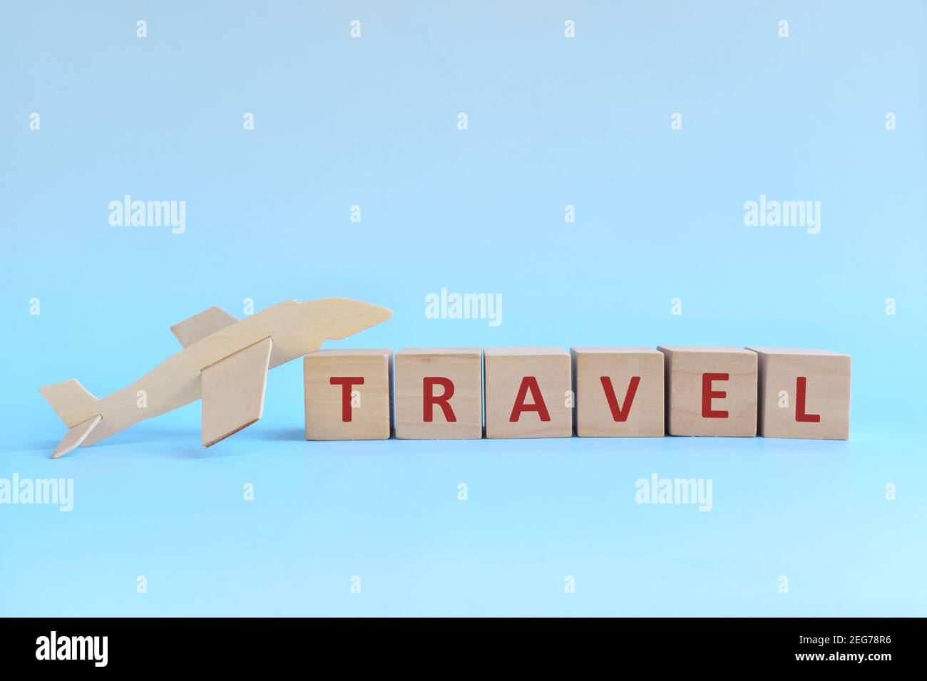 Wooden airplane model with blocks on sky blue background. Travel ...