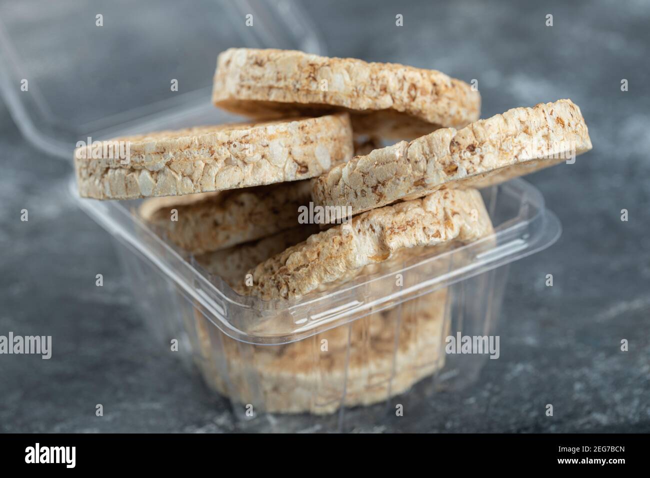 Crispy rice cakes in plastic container on surface Stock Photo - Alamy