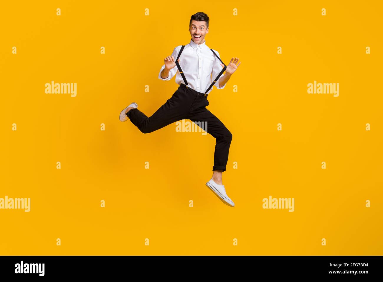 Full body photo of cheerful person hands playing with suspenders jump ...