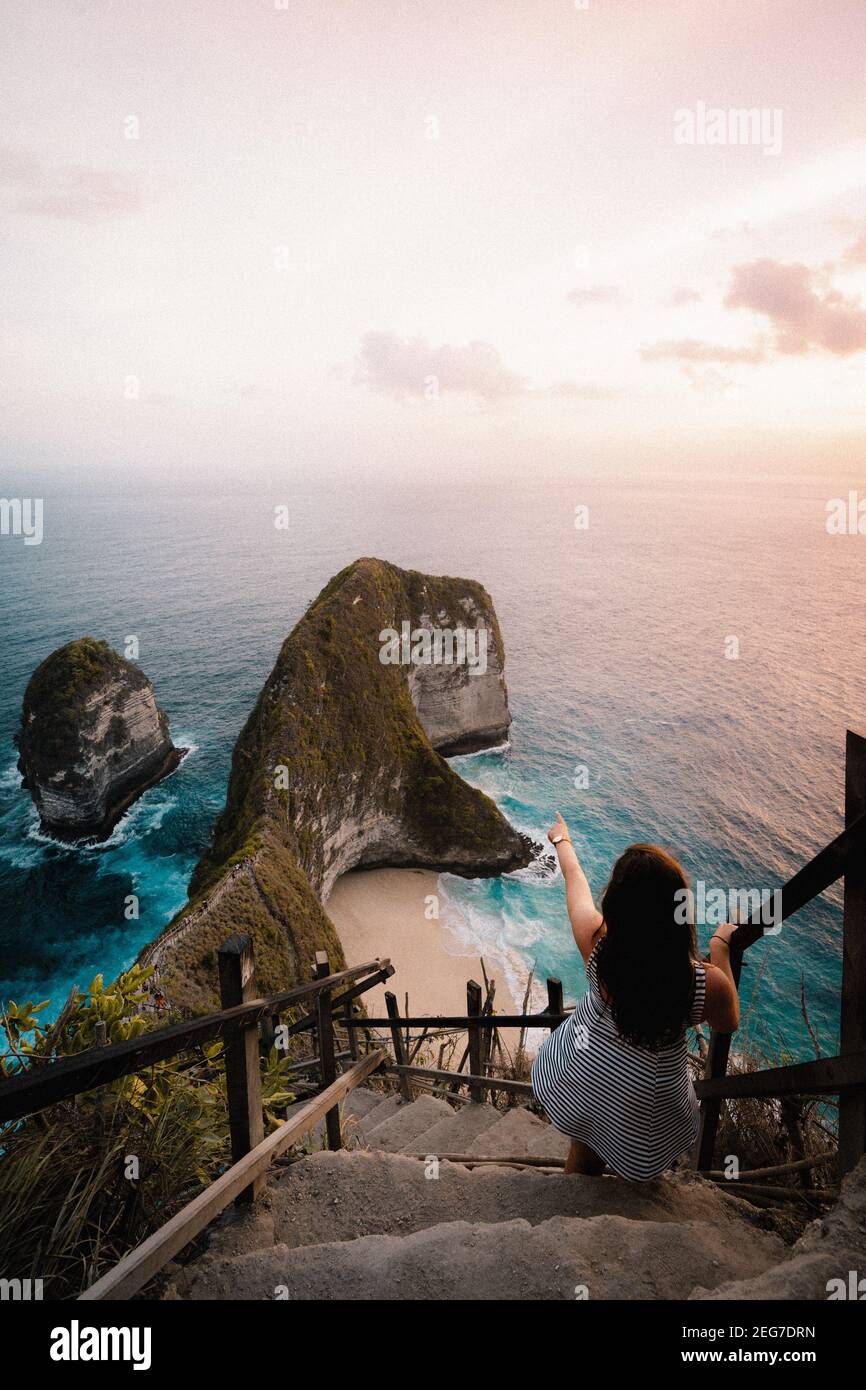 Back view of a woman going downstairs and enjoying the view of the ...