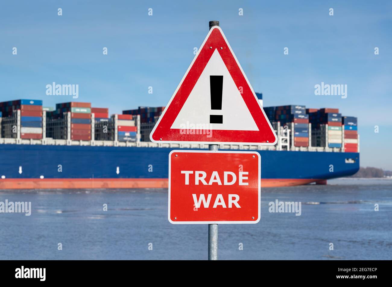 Warning sign with the text "Trade war" in front of a huge container ...