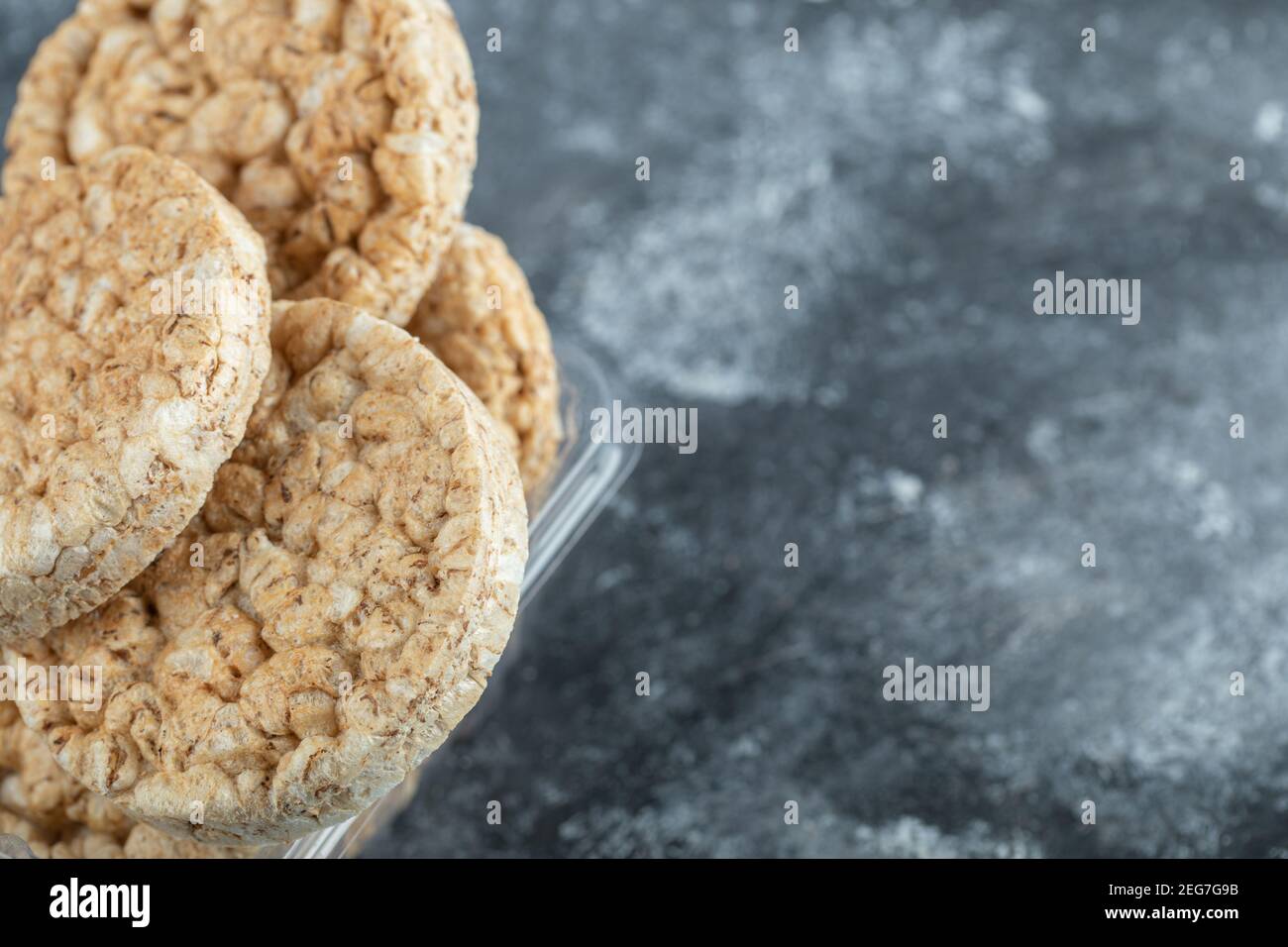 Crispy rice cakes in plastic container on surface Stock Photo - Alamy
