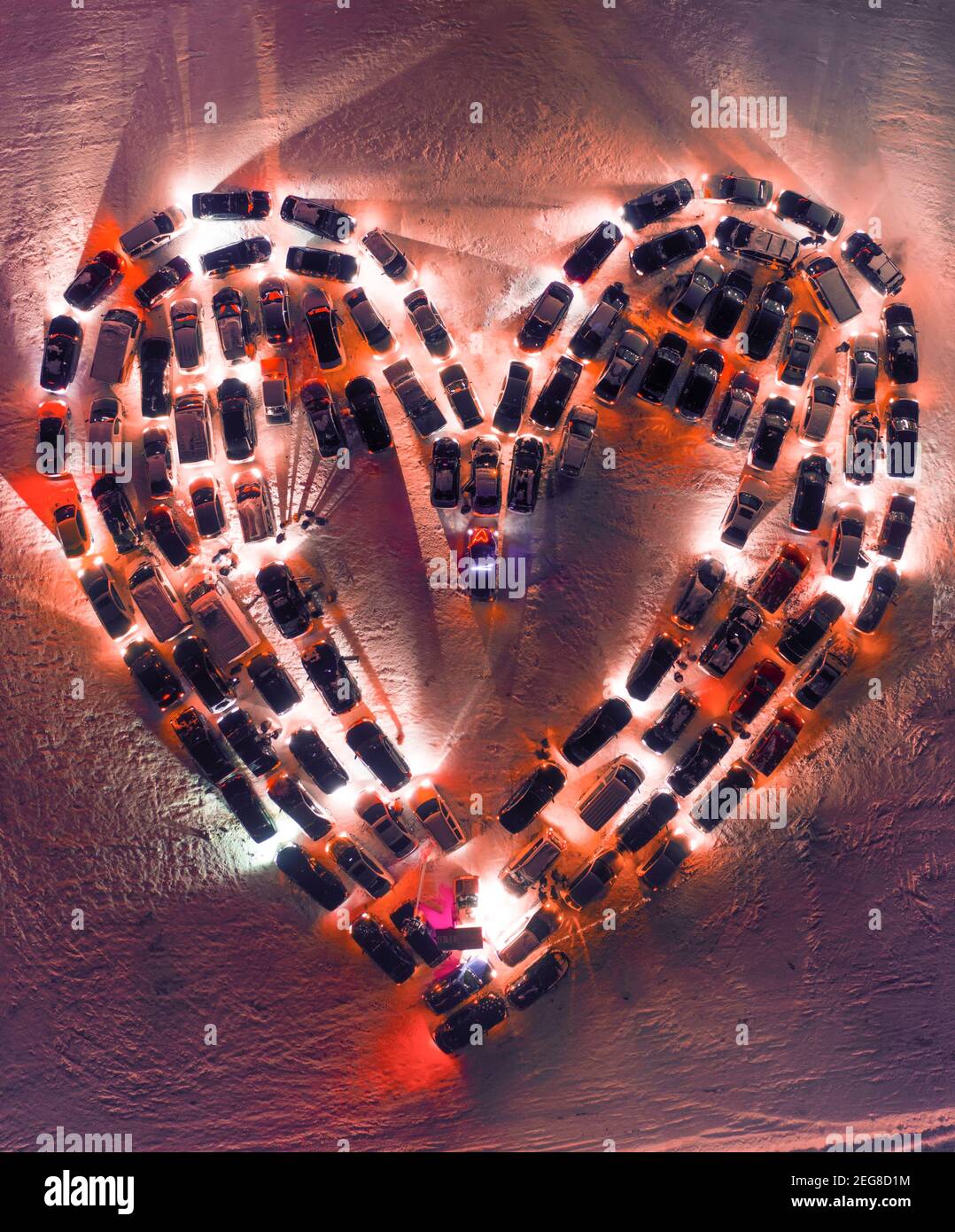 Cars parked in the shape of a heart in the parking lot. Aerial view ...
