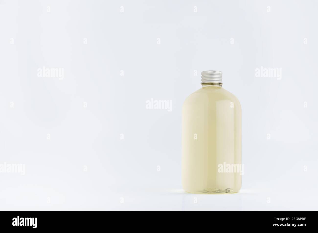 Transparent plastic low thick bottle with pale fresh drink or cosmetic ...