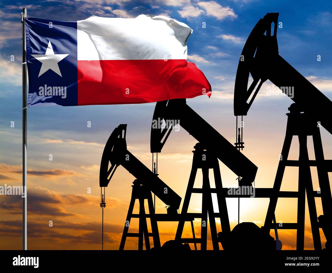 Oil rigs against the backdrop of the colorful sky and a flagpole with ...