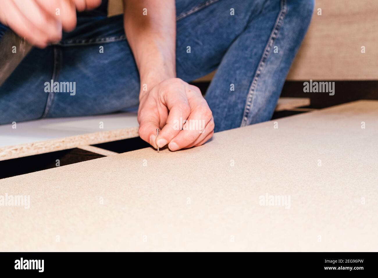 spinning bolts master worker man assembling furniture bed components ...