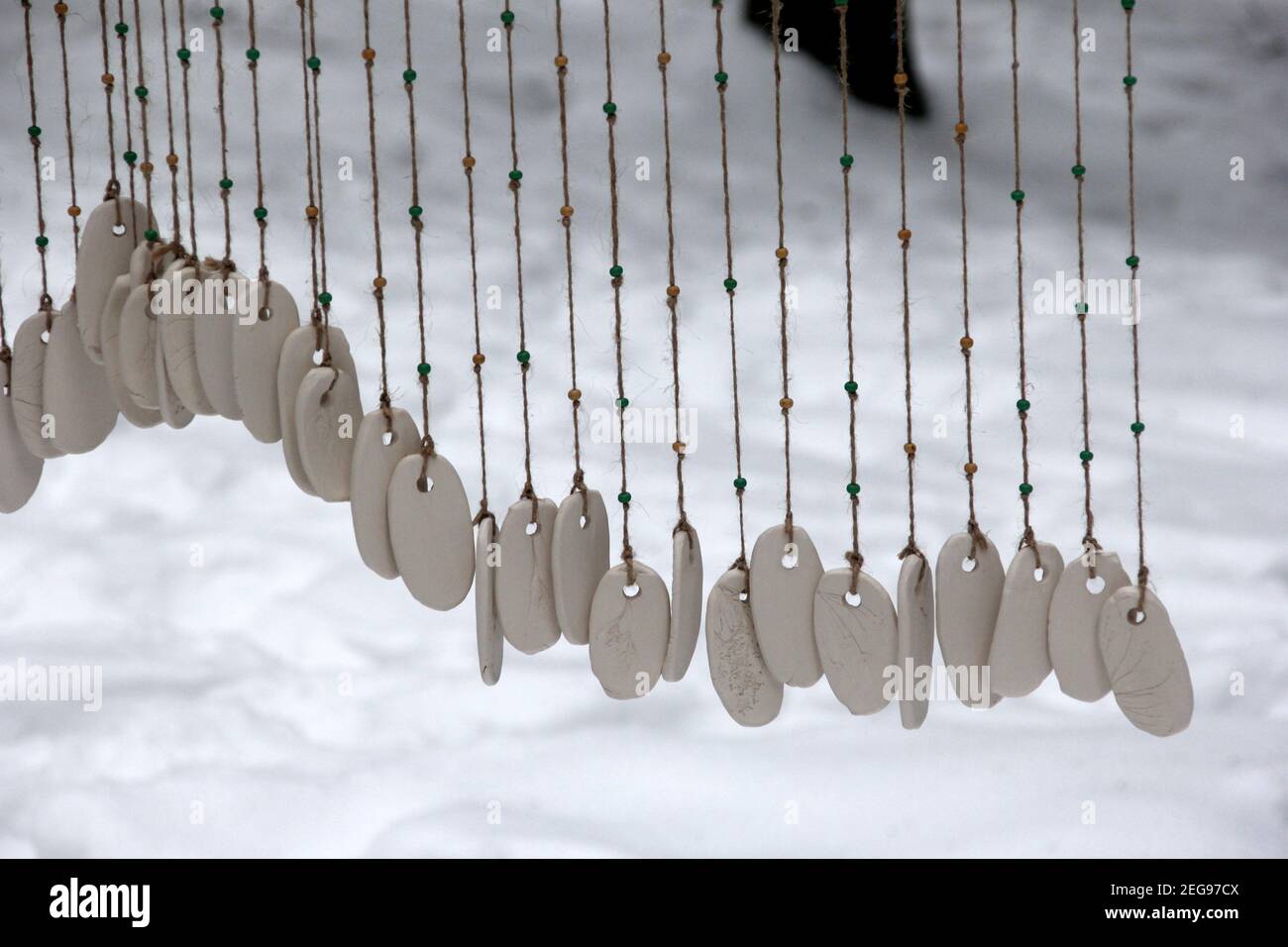 Hand made wind chimes hanging on a string with depth of field effect ...